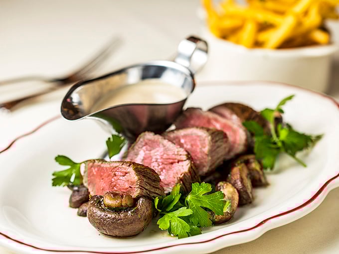Chateaubriand sliced to reveal that perfect rosy center, proving some classics never need reinvention.