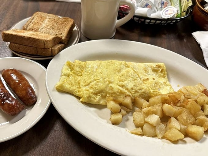 Simple pleasures done right &ndash; a perfectly folded omelet alongside home fries that strike that magical balance between crispy and tender.
