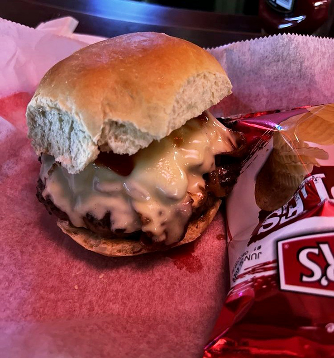 Half-eaten because waiting to take a photo was simply asking too much. This cheeseburger demands immediate attention with its melty cascade of cheese.