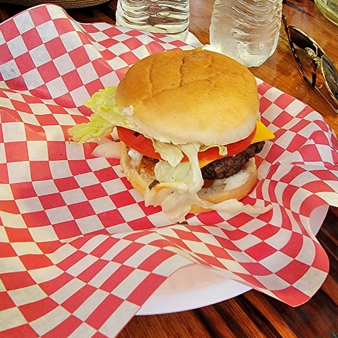 This isn't just a cheeseburger; it's a hand-formed masterpiece of beef, cheese, and fresh toppings served on a classic red-checkered wrapper &ndash; no pretension, just perfection.