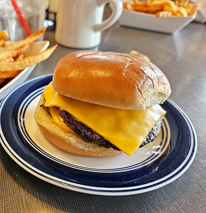Behold the cheeseburger in its natural habitat: unpretentious, perfectly melted, and ready to remind you why classics never go out of style.