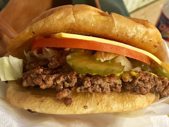 Architectural perfection: the ideal ratio of beef to cheese to fresh toppings. The Sistine Chapel of cheeseburgers exists in Jacksboro, Texas.