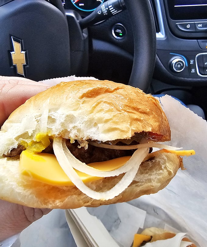 Behold the cheeseburger in its natural habitat&mdash;being devoured in a car. Some treasures are too precious to wait until you get home.