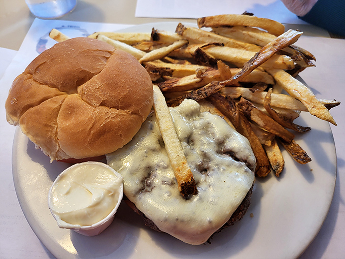 The cheeseburger deluxe arrives looking like it means business, with fries that could star in their own crispy potato commercial.