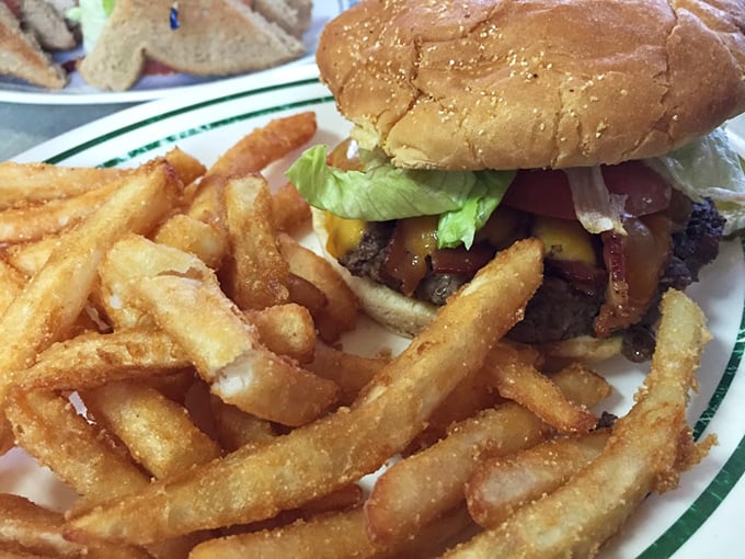 This isn't just a burger&mdash;it's architecture. Layers of beef, cheese, and fresh toppings supported by a foundation of perfectly crisp fries.