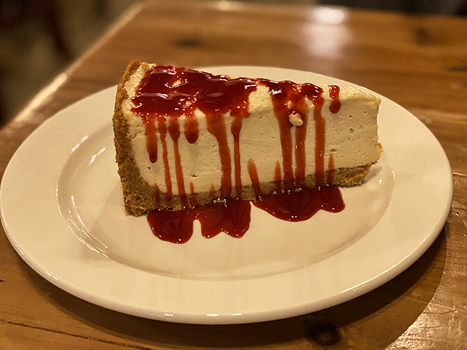 Cheesecake that makes you want to skip straight to dessert. That berry sauce isn't just drizzled&mdash;it's making a dramatic entrance worthy of Broadway.