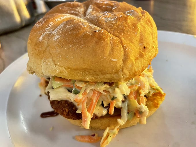 This isn't just a chicken sandwich&mdash;it's a masterpiece of textures and flavors, with creamy slaw providing the perfect counterpoint to the crispy chicken beneath.