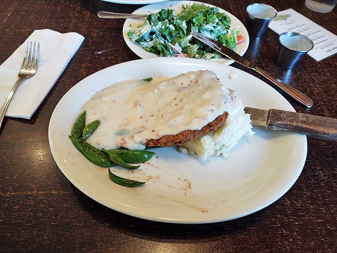 This chicken fried steak isn't just covered in gravy&mdash;it's blanketed in creamy, peppery comfort with a side of snap peas that somehow make you feel virtuous.