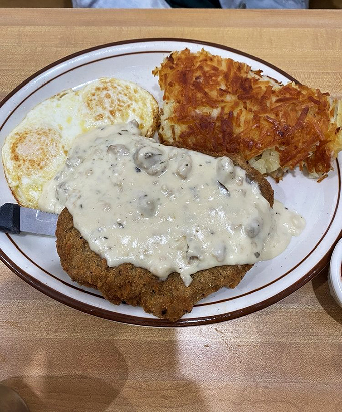 Country-fried steak smothered in gravy that your grandmother would approve of, paired with eggs and hash browns that define breakfast bliss.