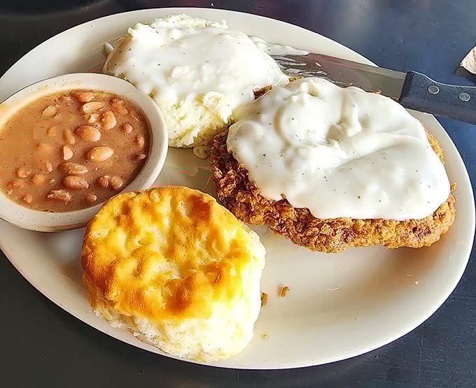 Chicken fried steak smothered in country gravy with green beans and a roll &ndash; the kind of plate that makes diets weep and cardiologists buy vacation homes.