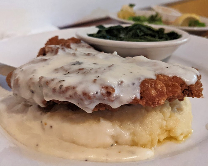 Behold the chicken fried steak—a masterpiece of crispy exterior giving way to tender meat, all swimming in gravy that could make a vegetarian reconsider their life choices.