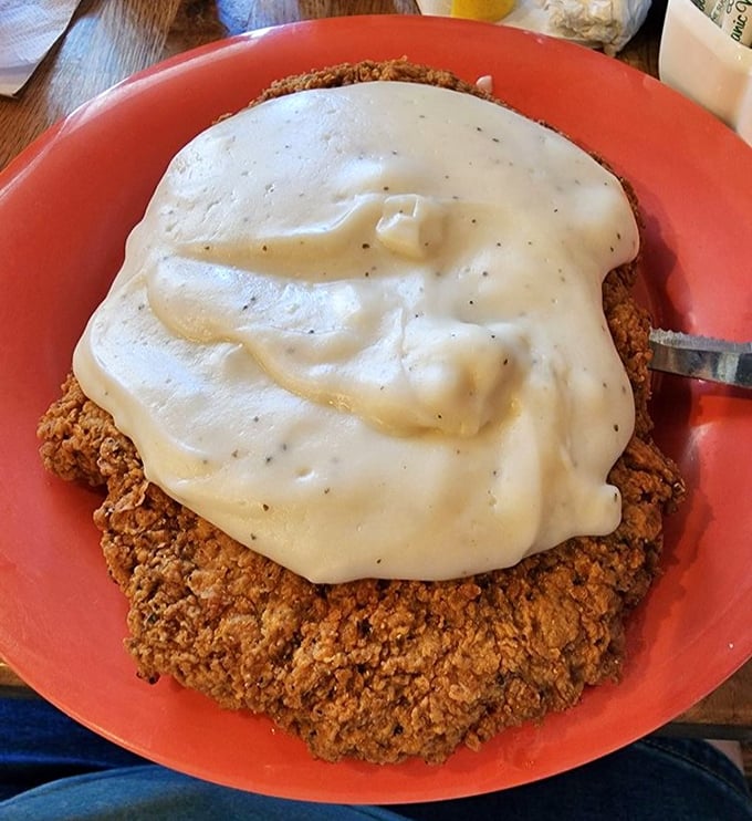 This chicken fried steak isn't just covered in gravy&mdash;it's swimming in a creamy ocean of peppery goodness. Southern comfort food that hugs your insides like a warm Texas greeting.