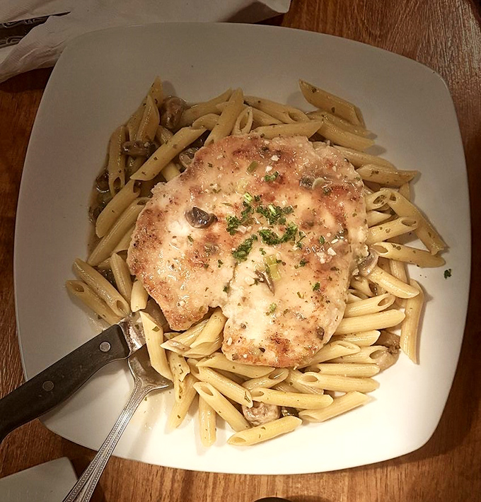Tender chicken nestled atop perfectly cooked penne—a dish that doesn't need fancy plating when it tastes like someone's Italian grandmother is in the kitchen.