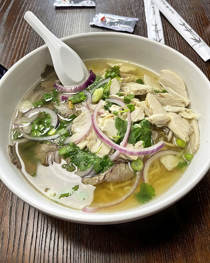 Clear broth, tender chicken, and fresh herbs create a pho that soothes the soul. The purple onions add both color and zing to this comforting bowl.