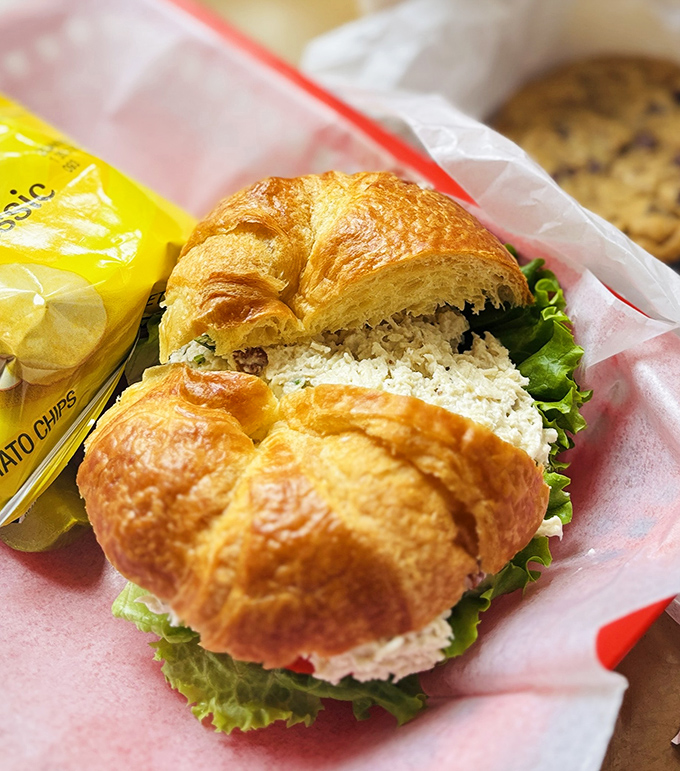 This chicken salad croissant isn't just a sandwich; it's architecture&mdash;flaky, buttery walls supporting a chicken salad interior that makes you wonder why you ever ate anything else.