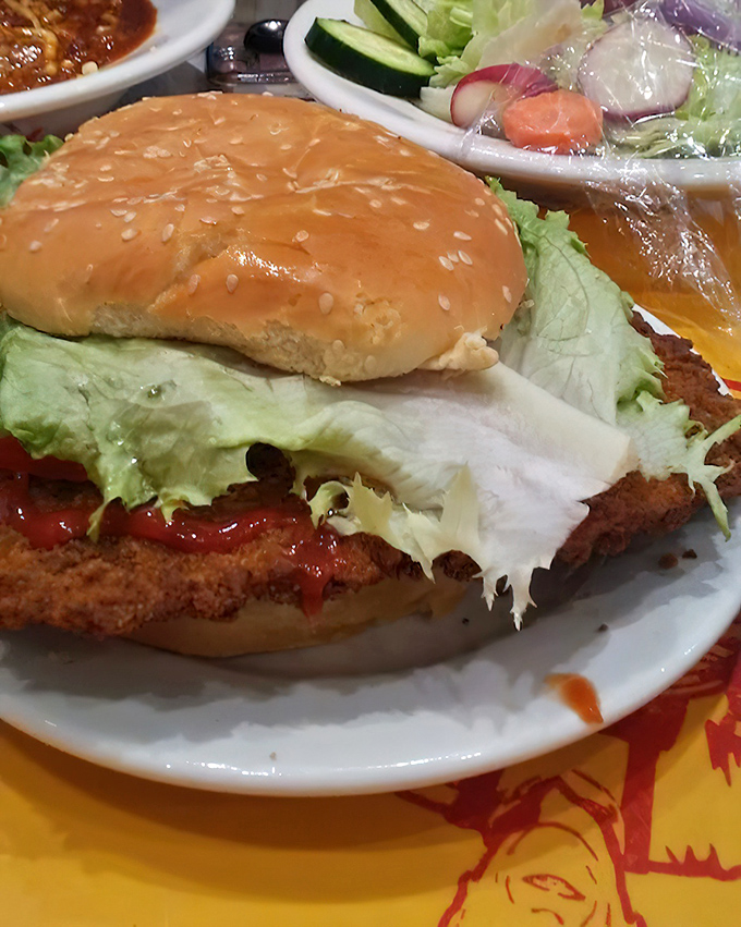 This isn't just a sandwich; it's an engineering marvel. The golden-brown breaded tenderloin with its perfect lettuce-to-condiment ratio defies conventional bun physics.
