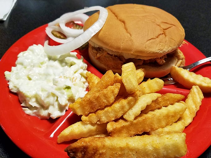 Golden-fried chicken on a toasted bun, flanked by fries and slaw, looking like comfort food's greatest hits album.