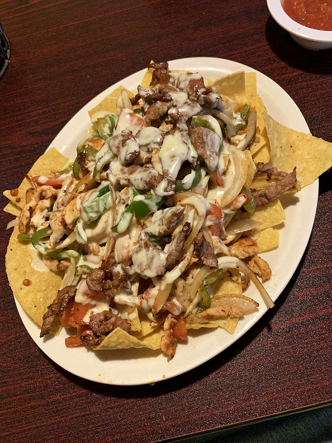 Nachos aren't just an appetizer here&mdash;they're an architectural achievement. Layers of meat, cheese, and veggies balanced so precisely that each bite delivers the perfect ratio of crunch to gooey.