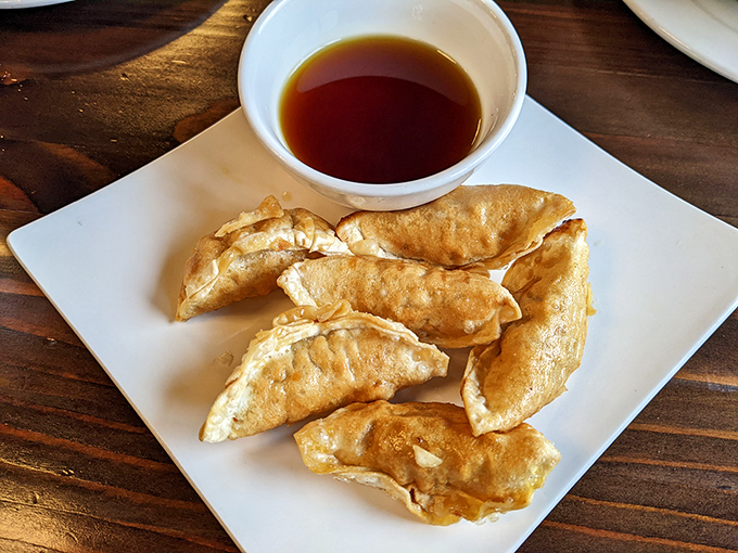 Golden-fried dumplings that crackle with promise. These crispy pockets deliver a satisfying crunch before revealing their savory treasures within.
