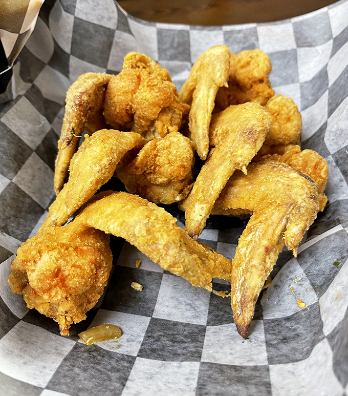 These golden-fried chicken wings aren't just crispy&mdash;they're having a meaningful relationship with whatever seasoning makes them impossible to photograph without stealing one first.