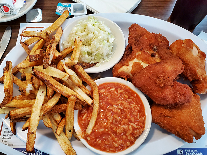 The complete Barberton chicken experience: crispy chicken, tangy hot sauce, vinegary slaw, and hand-cut fries that could start their own fan club.