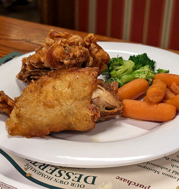 Golden-fried chicken that crackles with each bite, paired with vibrant vegetables that somehow make you feel virtuous while indulging.