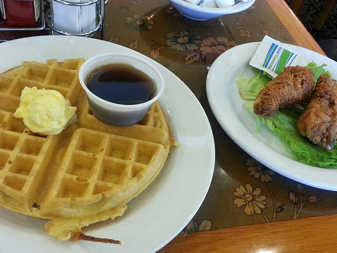 Golden waffle meets crispy bacon meets sweet syrup—a breakfast trinity that proves sometimes the simplest combinations are the most divine.