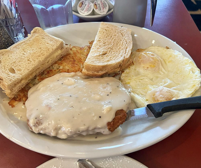Comfort on a plate&mdash;country-fried steak smothered in creamy gravy alongside sunny eggs and toast that's ready to soak up every last delicious drop.