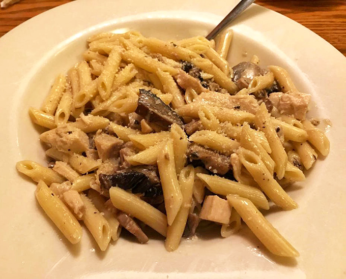 Comfort food perfection: penne pasta with chicken and mushrooms in a creamy sauce that would make an Italian grandmother nod in approval.