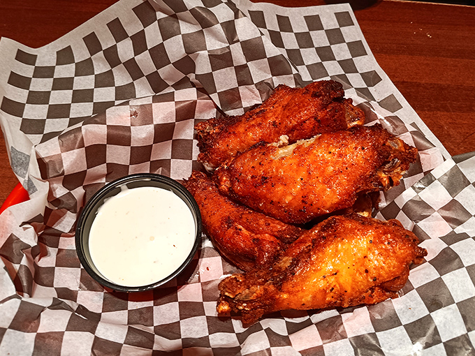 Wings with attitude—crispy, saucy, and unapologetically messy. That dipping sauce isn't just a condiment, it's a supporting character in this delicious drama.