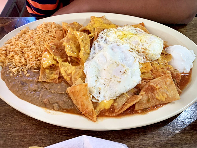 Chilaquiles perfection: crispy-yet-tender tortilla chips, vibrant sauce, runny eggs, and that magical balance that turns breakfast into an out-of-body experience.