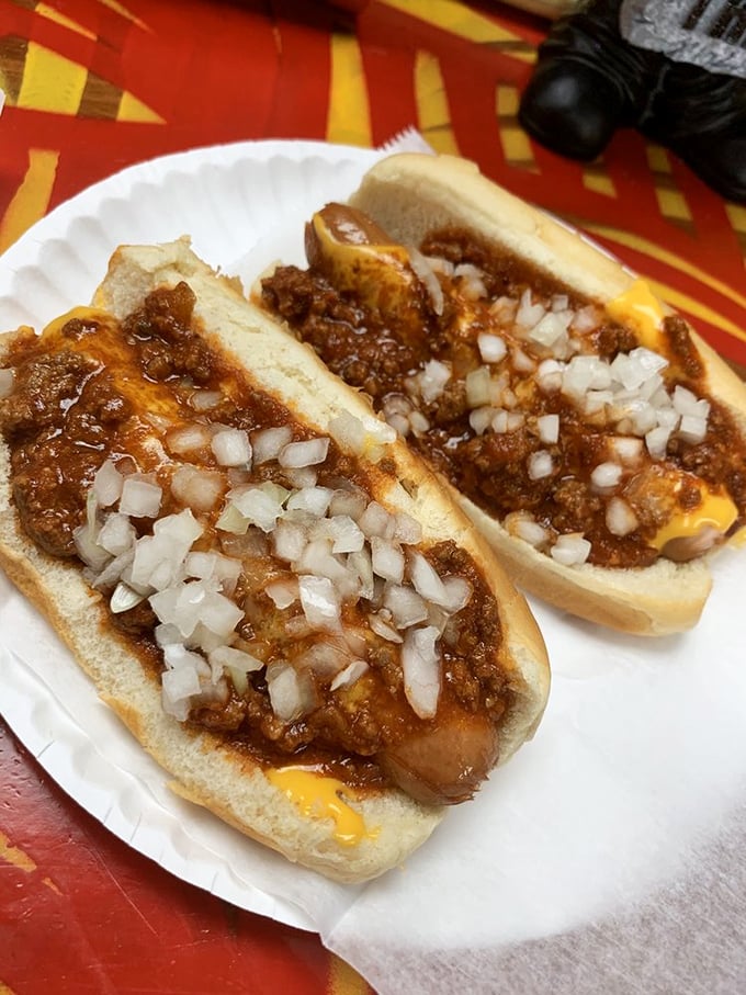 Chili, cheese, and onions piled high on perfectly grilled franks &ndash; messy, glorious, and absolutely worth every napkin you'll need to use here.