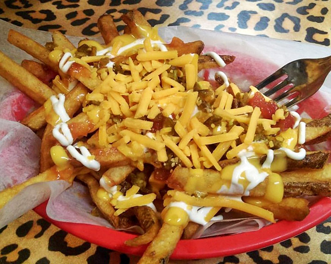 Loaded fries that make you question why you'd ever eat them plain again&mdash;a glorious mess of cheese, chili, and condiments worth every napkin.