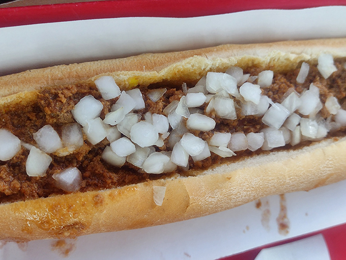 The chili dog in its natural habitat&mdash;simple, unpretentious, and topped with a snowfall of diced onions. Napkins required, regrets forbidden.