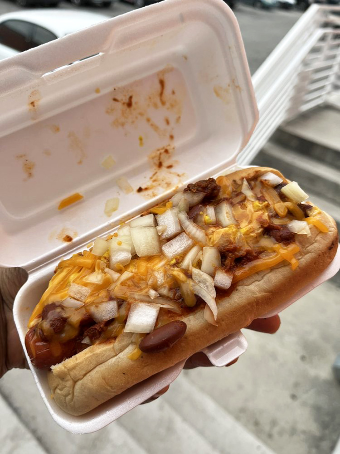 The chili dog that launched a thousand napkins. Melted cheese and diced onions join the party, creating a handheld masterpiece worth the mess.