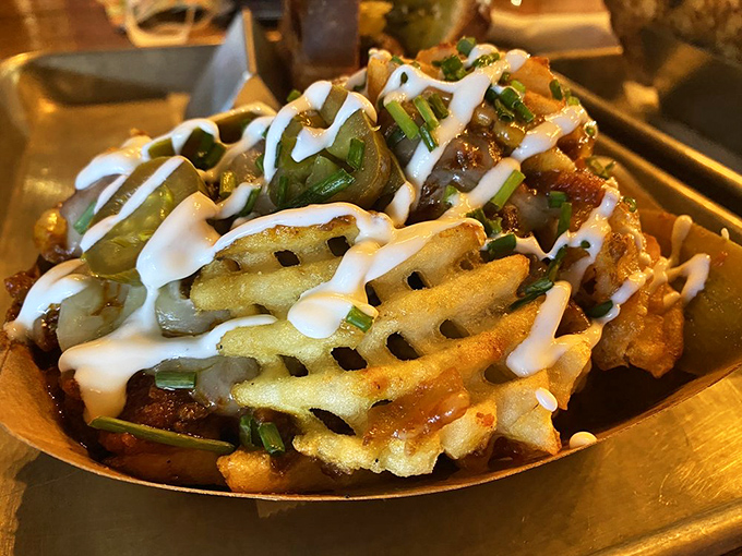 Waffle fries elevated to art form status. Crispy lattice potatoes playing host to a party of toppings that would make even the most dignified diner lick their fingers.