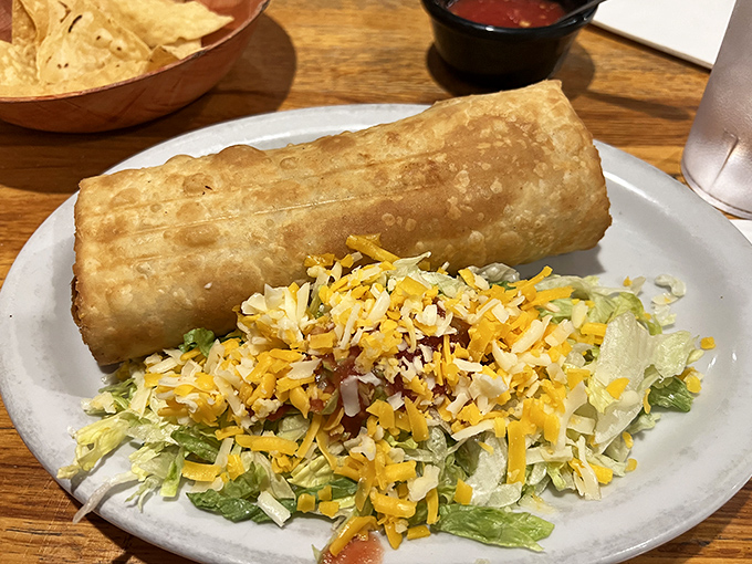 The chimichanga: where a burrito goes to fulfill its destiny of being gloriously fried and achieving golden perfection alongside a garden of shredded lettuce.