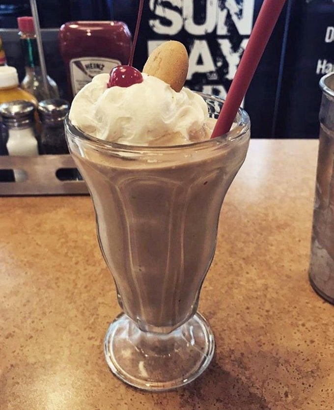 Not all milkshakes are created equal. This one's so thick the cherry and cookie garnish stand at attention like they're guarding Fort Knox.