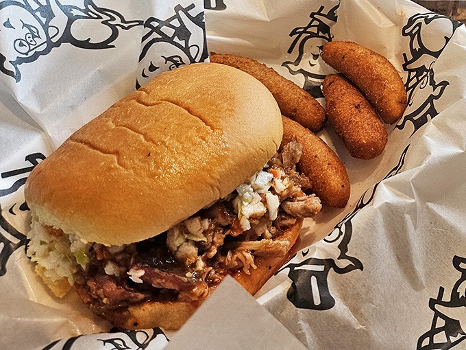 The chopped barbecue sandwich&mdash;North Carolina's greatest contribution to handheld happiness, accompanied by hush puppies that deserve their own fan club.