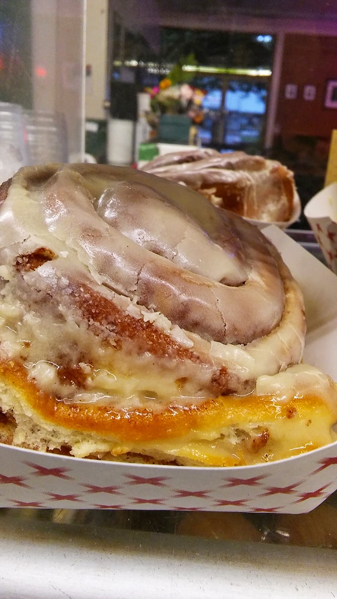 This isn't just a cinnamon roll; it's a spiral-shaped happiness delivery system with glaze that glistens like morning dew.