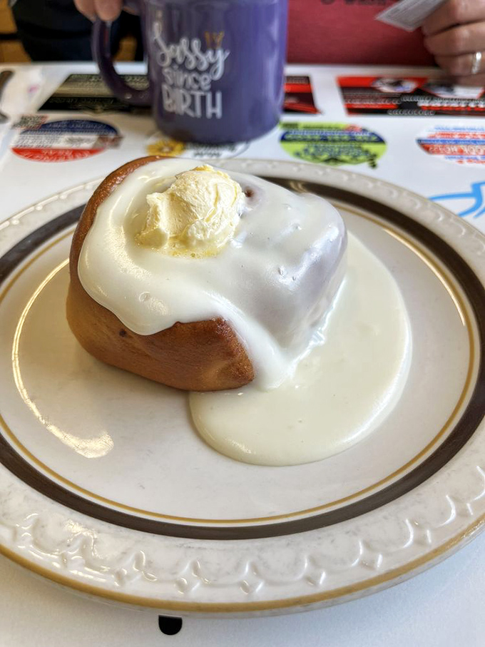 This cinnamon roll isn't just topped with icing&mdash;it's wearing a crown of melting butter like it knows it's breakfast royalty.