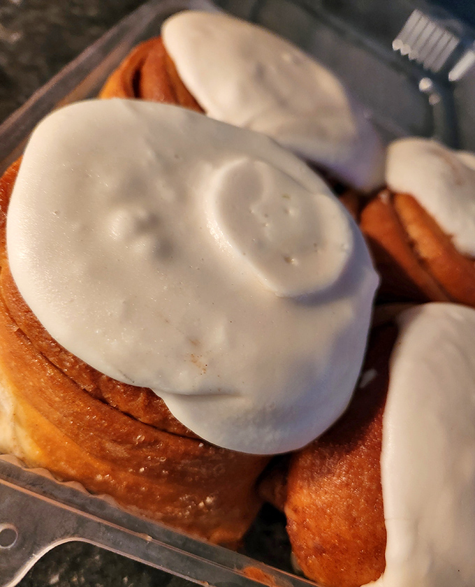 Cinnamon rolls wearing their Sunday best &ndash; those white frosting hats aren't just toppings, they're crowns for pastry royalty.