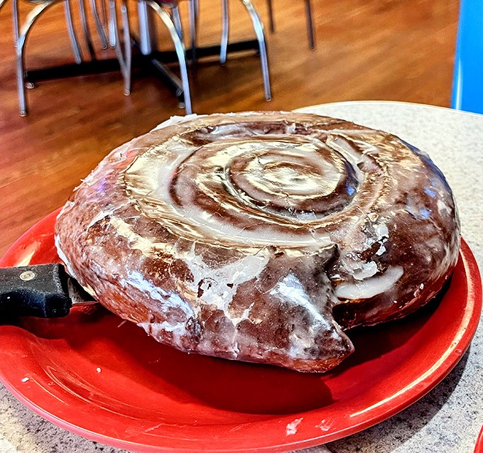 This isn't just a cinnamon roll; it's a spiral-bound love letter to butter, sugar, and spice. Resistance is futile, napkins are mandatory.