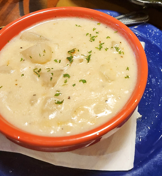 Creamy comfort in a bowl. This New England clam chowder, dotted with tender clams and fresh herbs, might make you forget you're in Florida.