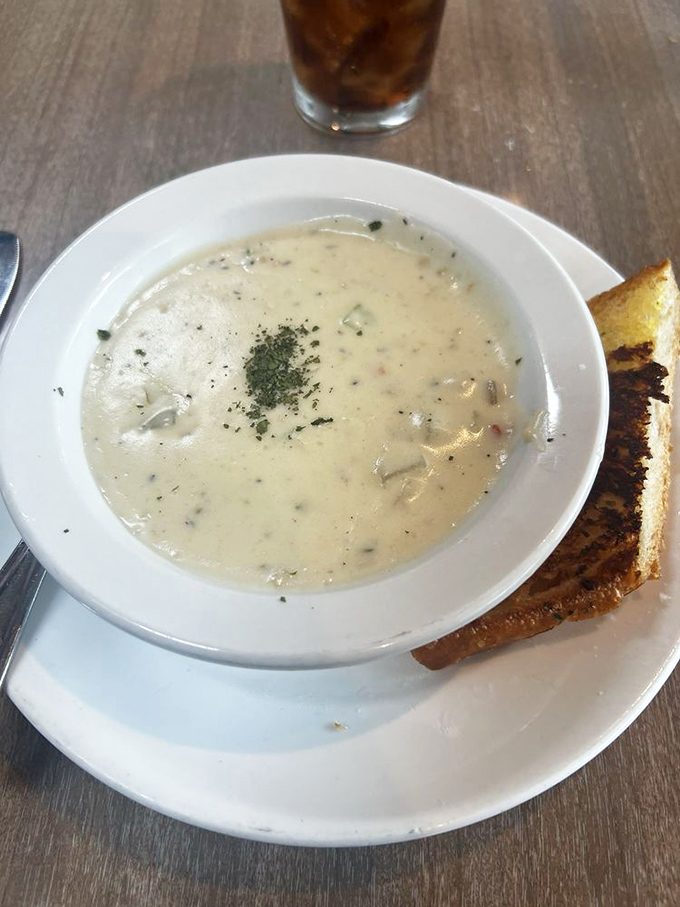 Clam chowder that would make a New Englander weep with joy, served alongside garlic bread that's worth the extra gym time tomorrow.