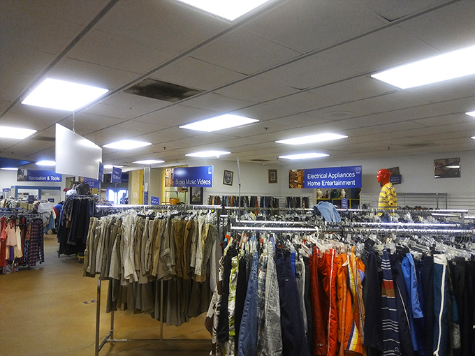 In traditional retail, these clothes would be neatly folded on shelves. Here, they're geological layers waiting to be excavated by determined treasure seekers.