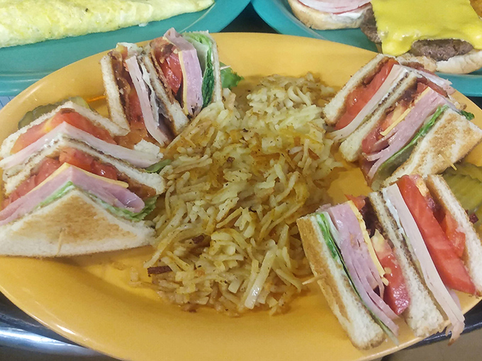 The club sandwich&mdash;architecture's greatest contribution to lunch&mdash;stacked higher than a Tennessee mountain and surrounded by a golden moat of hash browns.