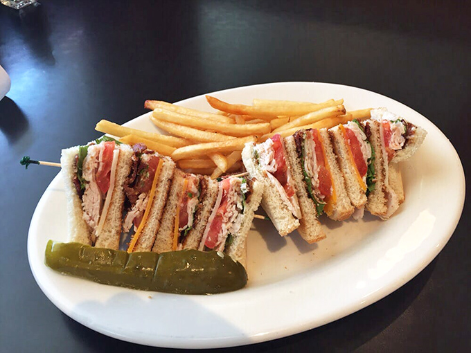 A club sandwich that's architectural perfection &ndash; layers of goodness standing tall like delicious skyscrapers with a pickle spire.