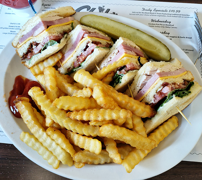 This club sandwich isn't just stacked with layers &ndash; it's stacked with flavor, accompanied by crinkle-cut fries that would make any potato proud.