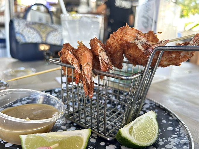 These coconut shrimp aren't just fried—they're transformed into crispy, golden treasures served in a whimsical shopping cart that says "take me home."